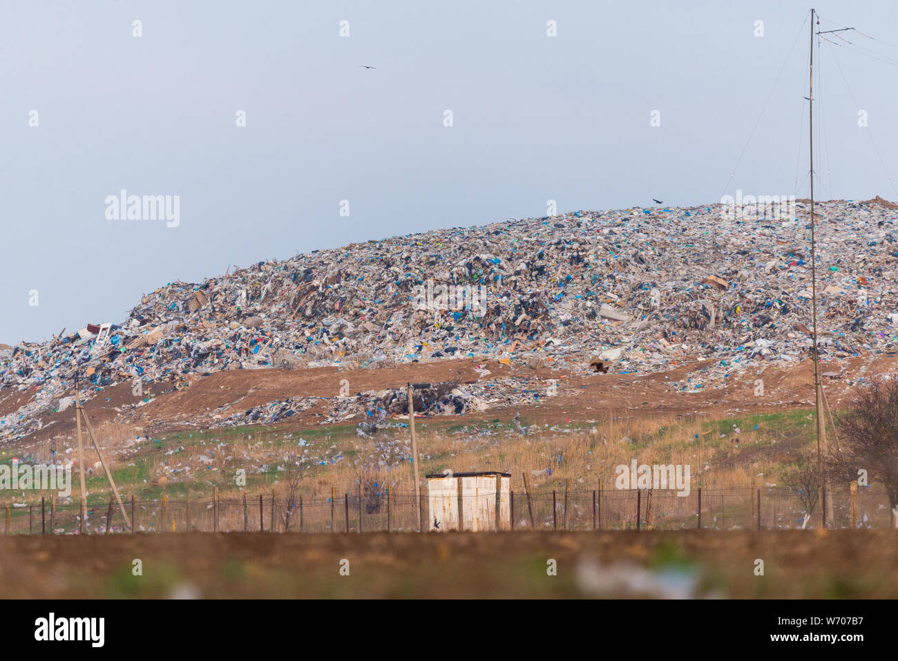 View of a big landfill outside the city behind the gate Stock Photo - Alamy