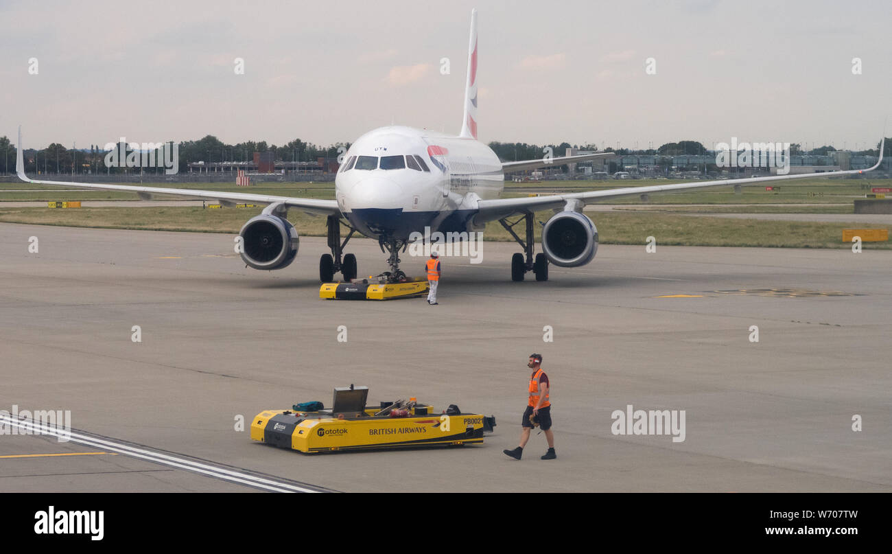 A Mototok remote control electric tug moves a British Airways plane at ...