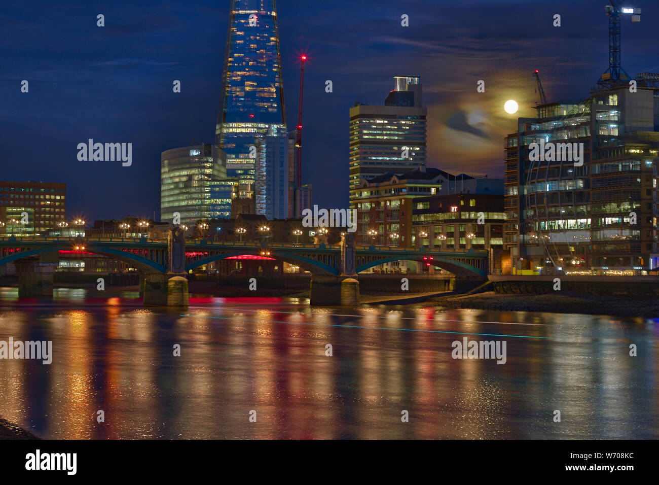 full moon over London bridge, River thames and Shard building in ...