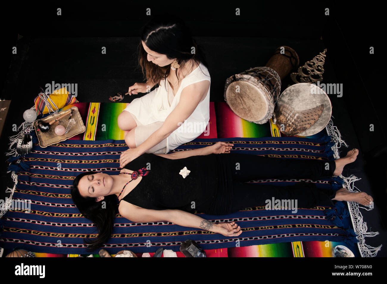 Shamanic women performing luminous healing ritual Stock Photo - Alamy