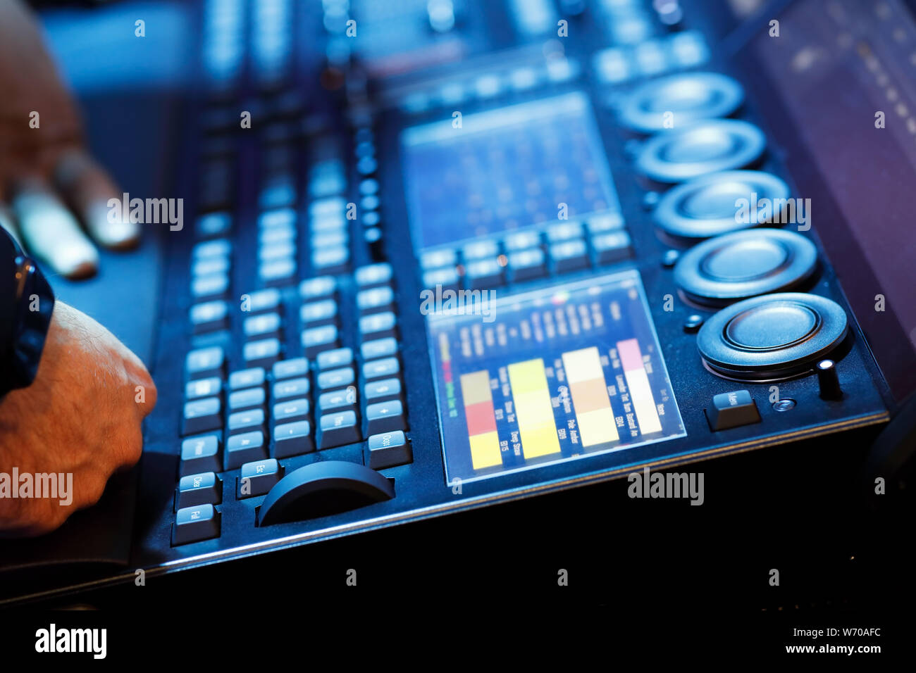 Operator working with lighting control console. Selective focus Stock ...