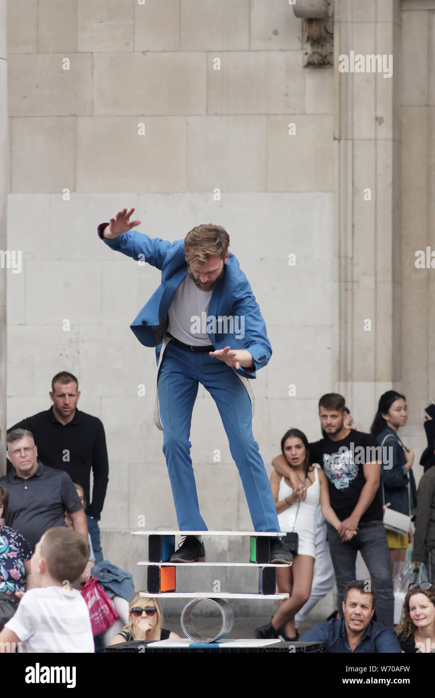 London, UK. 3rd Aug 2019. A perilous balancing act by a street ...
