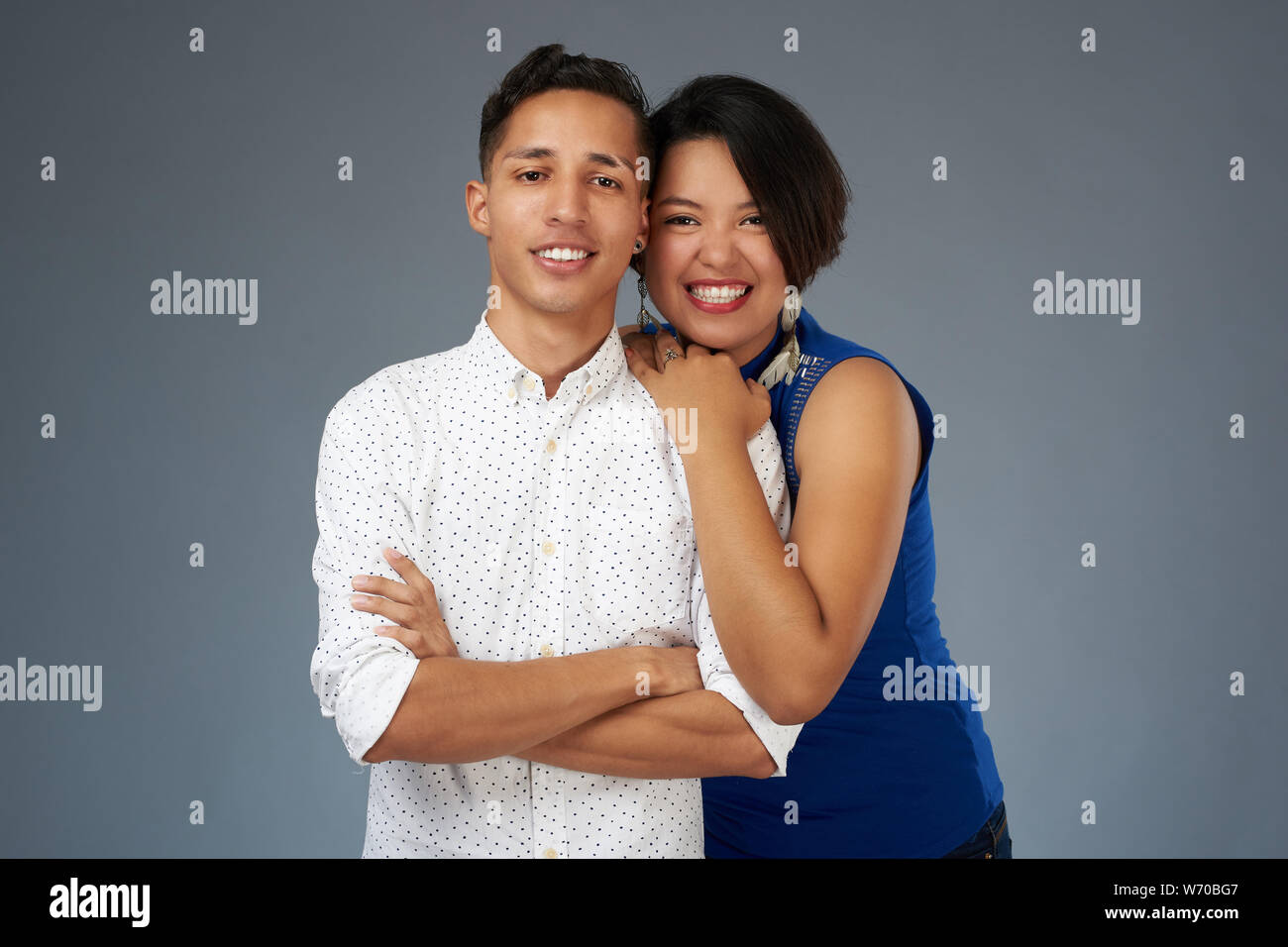Portrait of young latin couple isolated on gray studio background Stock ...