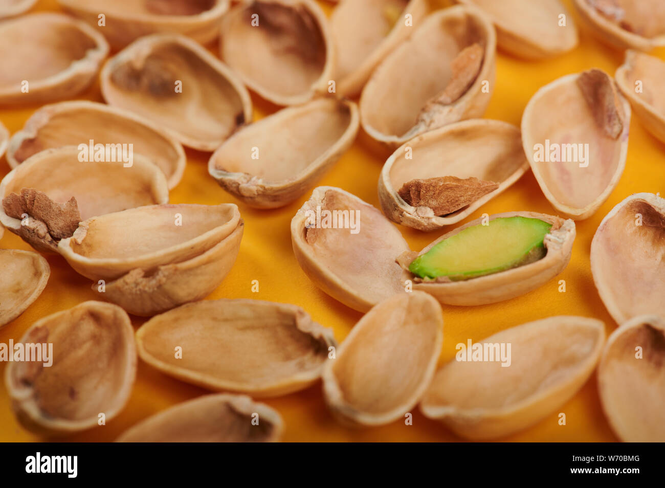 Eating pistachio theme. Close up of green pistachio nut around empty ...