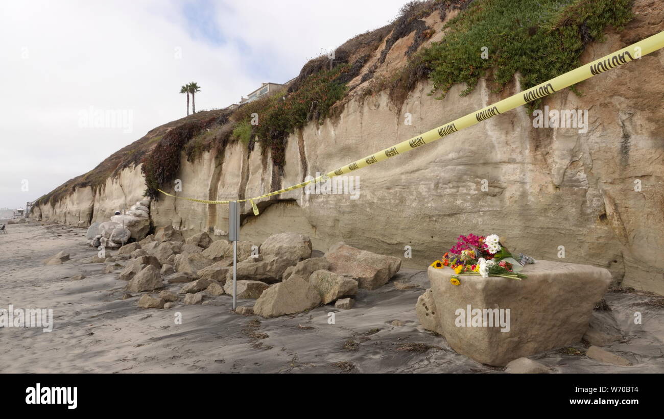 Signs and caution tape warn of unstable cliffs at Grandview Beach in ...