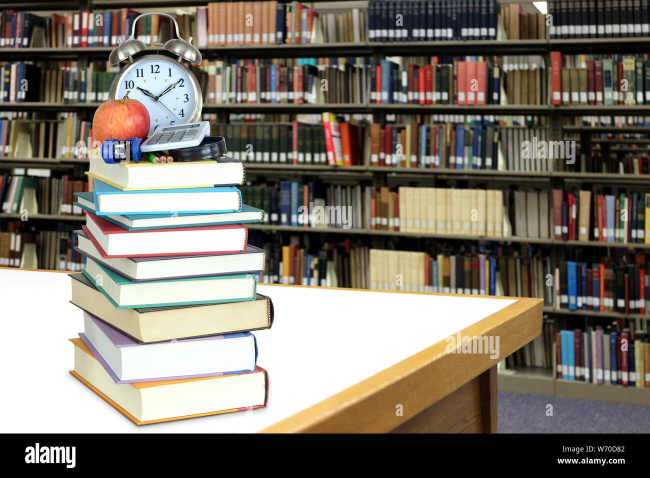 education concept with book and clock in library Stock Photo - Alamy