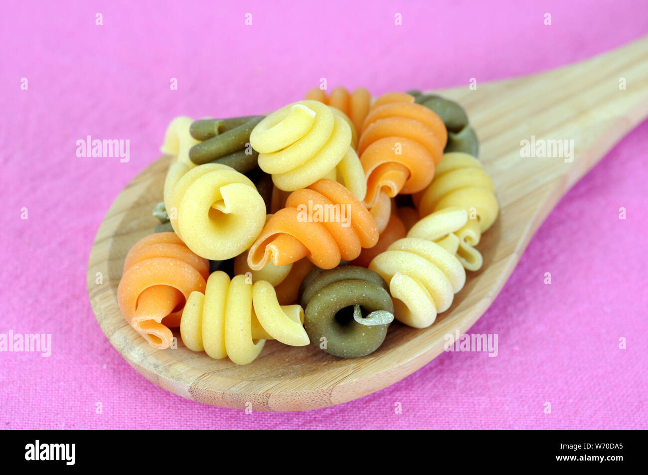 colorful trottole pasta shape in the wooden spoon Stock Photo - Alamy