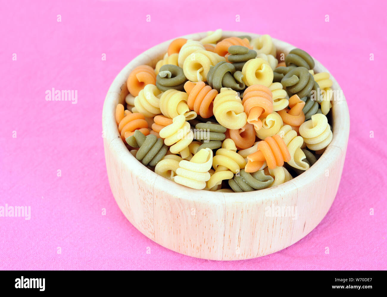 colorful trottole pasta shape in the wooden bowl Stock Photo - Alamy
