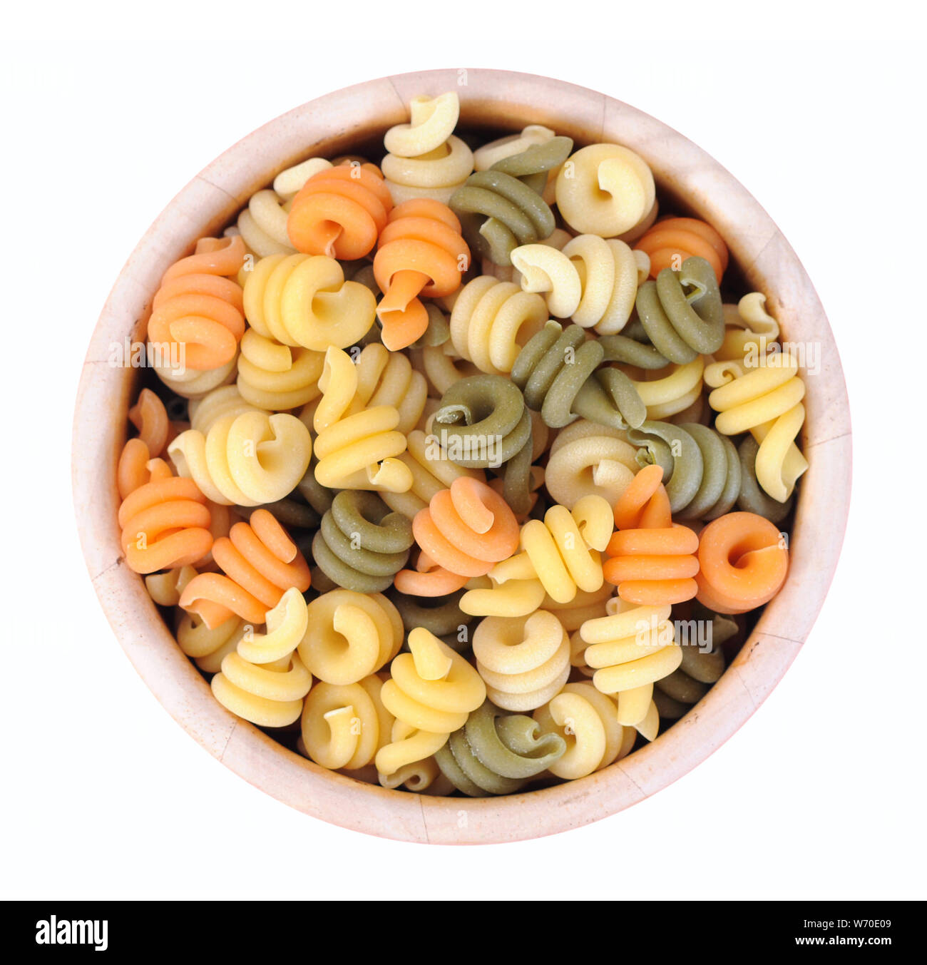 colorful trottole pasta shape in wooden bowl isolated on white Stock ...