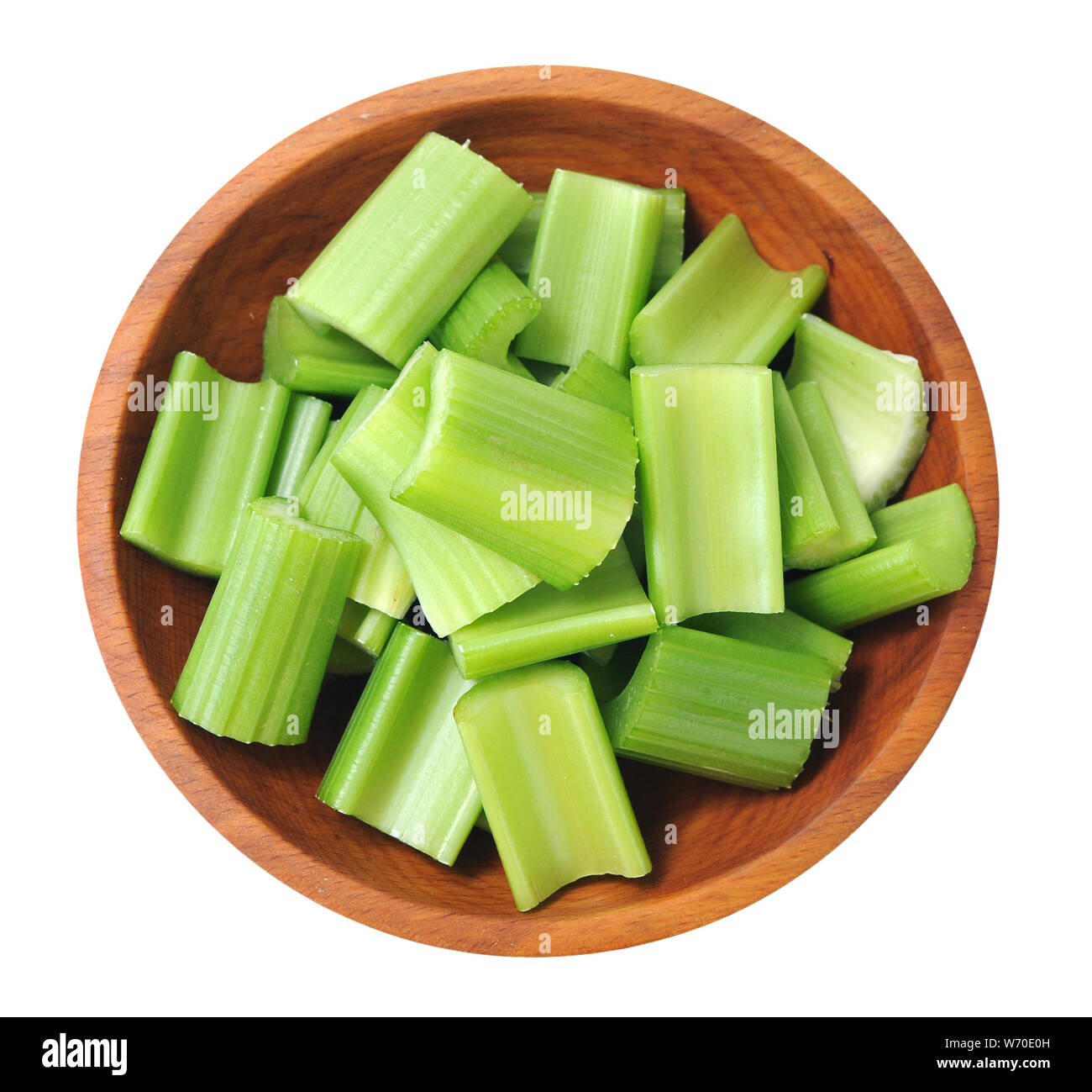 chopped celery in wooden bowl isolated on white background Stock Photo ...
