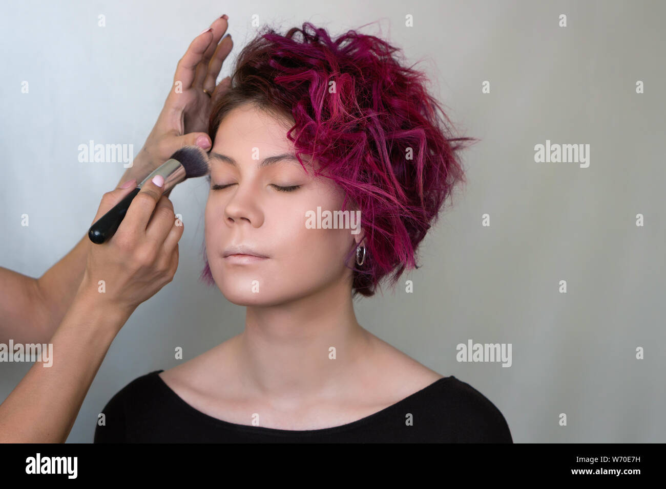 Makeup artist applies foundation concealer on your face model special ...