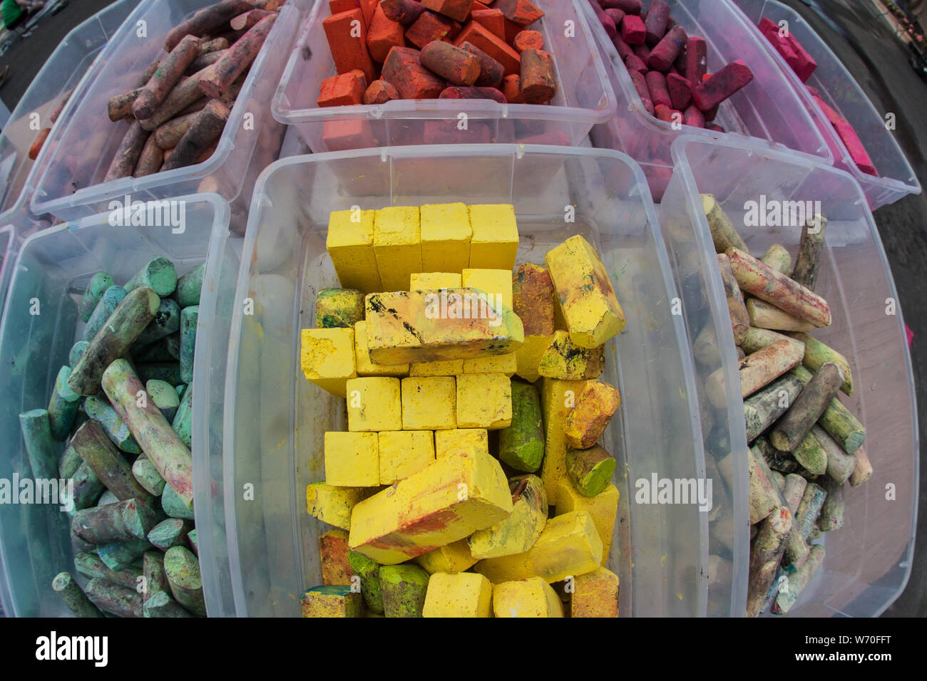Colorful pieces of chalk sit in plastic containers at chalk art contest ...