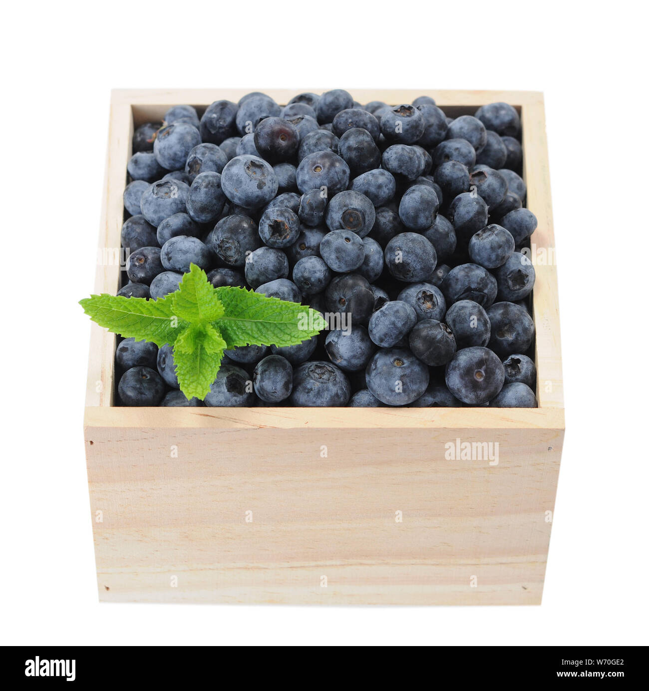 a group of blueberry in wooden bucket isolated on white Stock Photo - Alamy