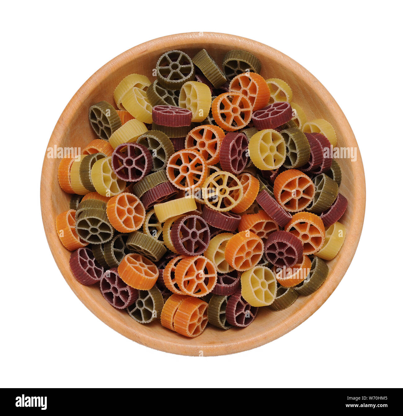 colorful rotelle pasta in wooden bowl isolated on white background ...