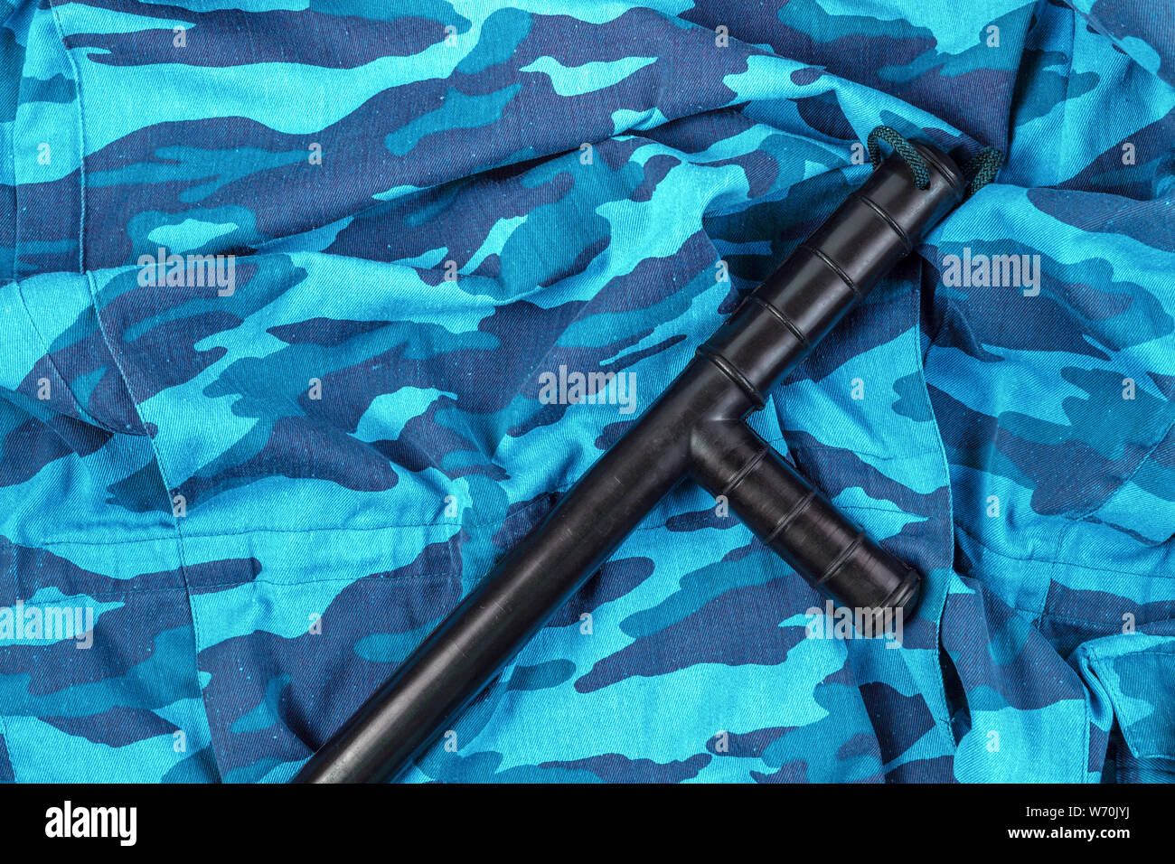 black rubber baton on blue urban russian riot police camouflage flat ...