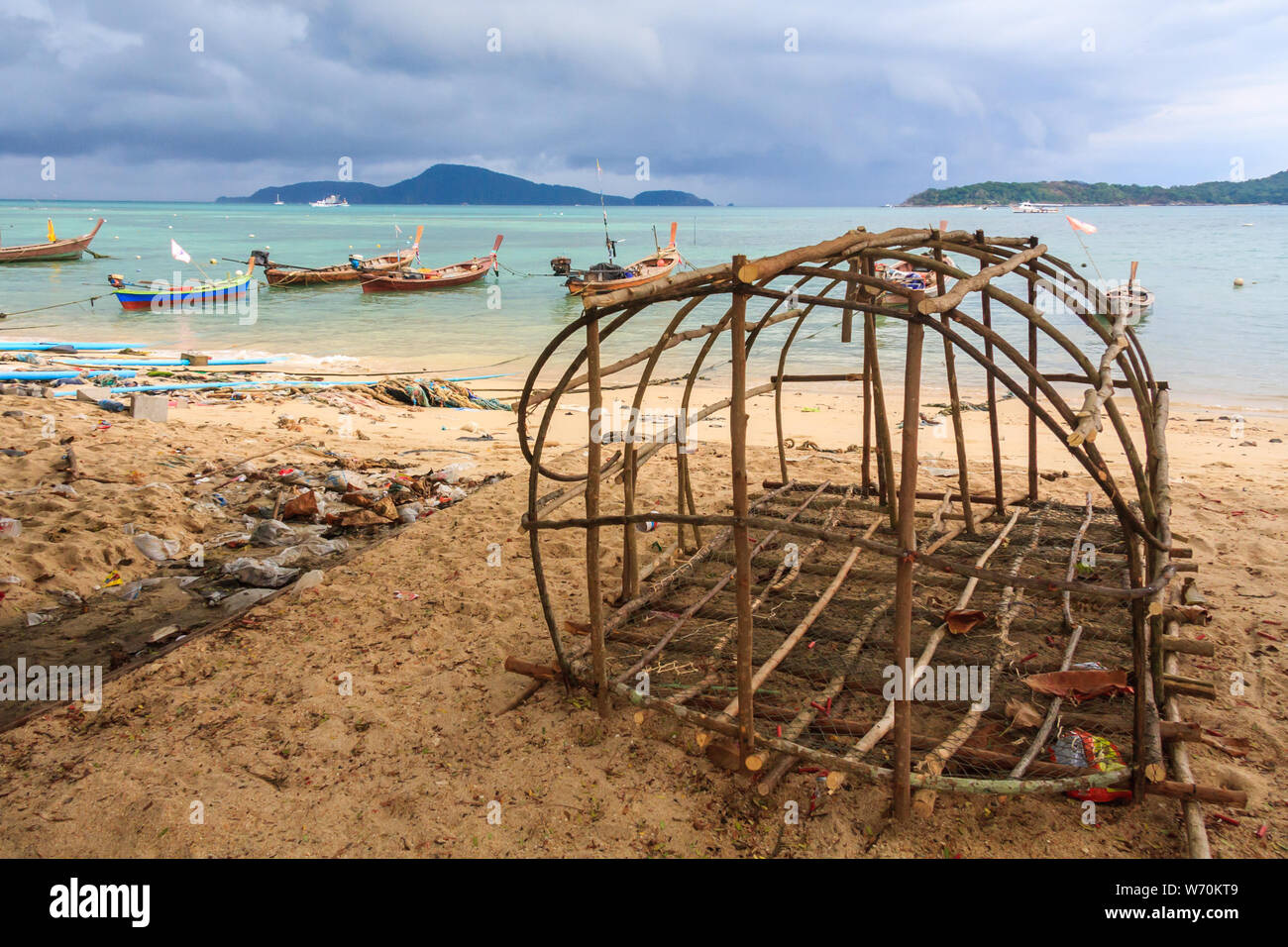 Fish trap and boats under a stormy looking sky, Rawai, Phuket, Thailand ...