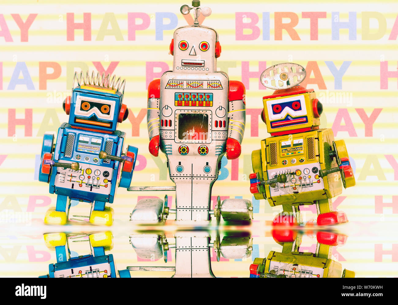 three retro bots with HAPPY BIRTHDAY background toned image Stock Photo ...