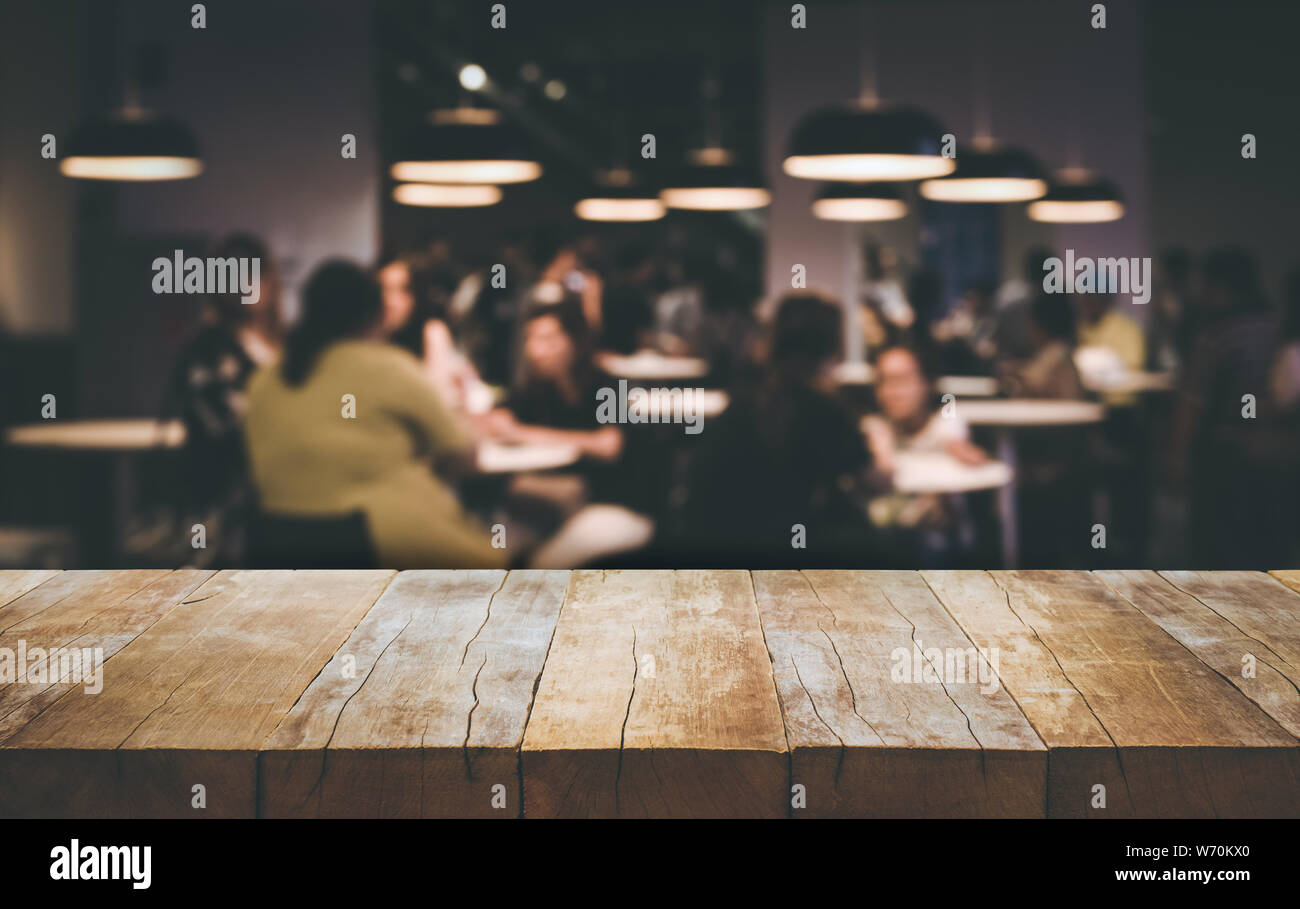Wood table top (Bar) with blur people siting in cafe background ...