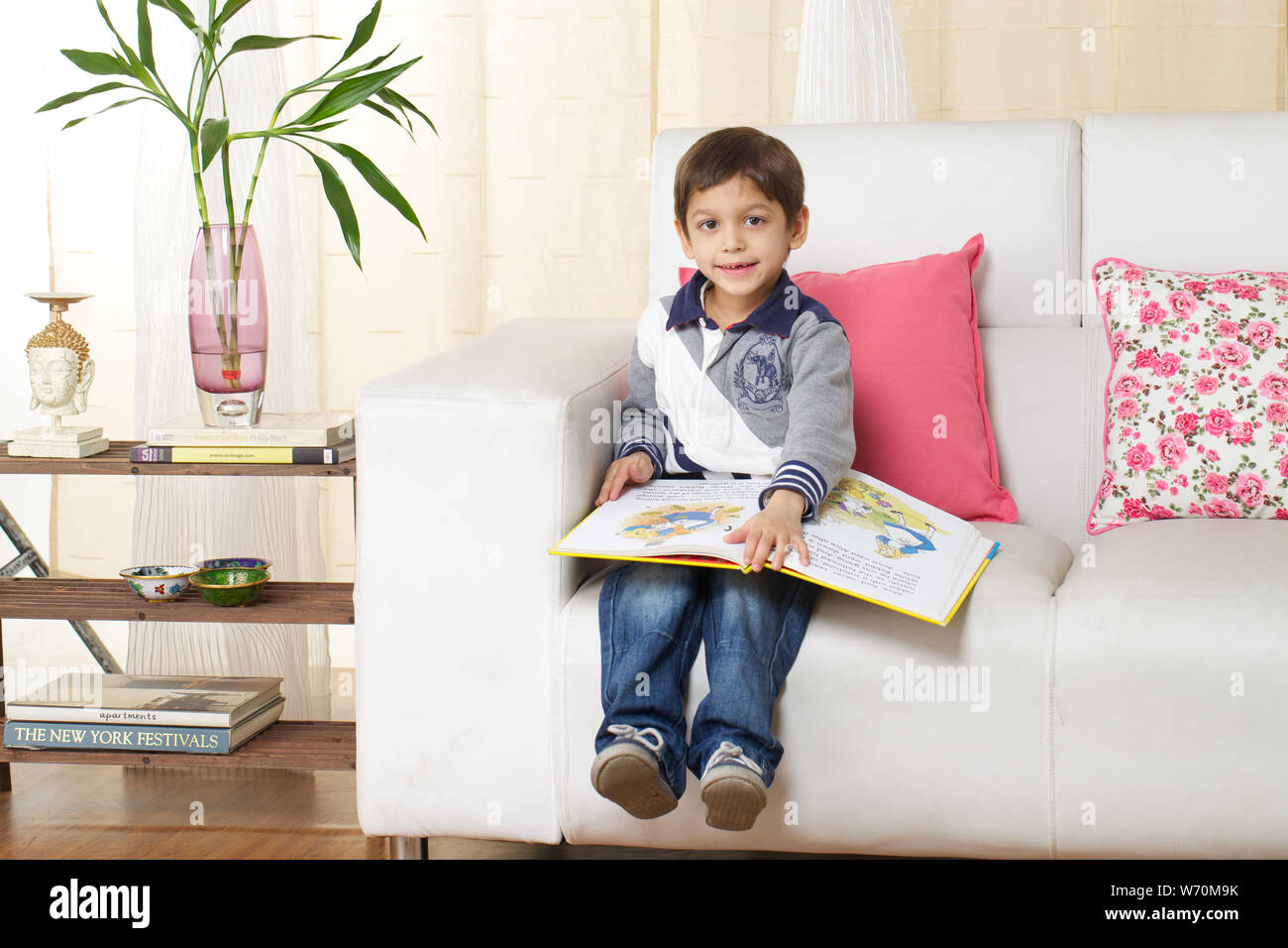 Boy reading a book at home Stock Photo - Alamy