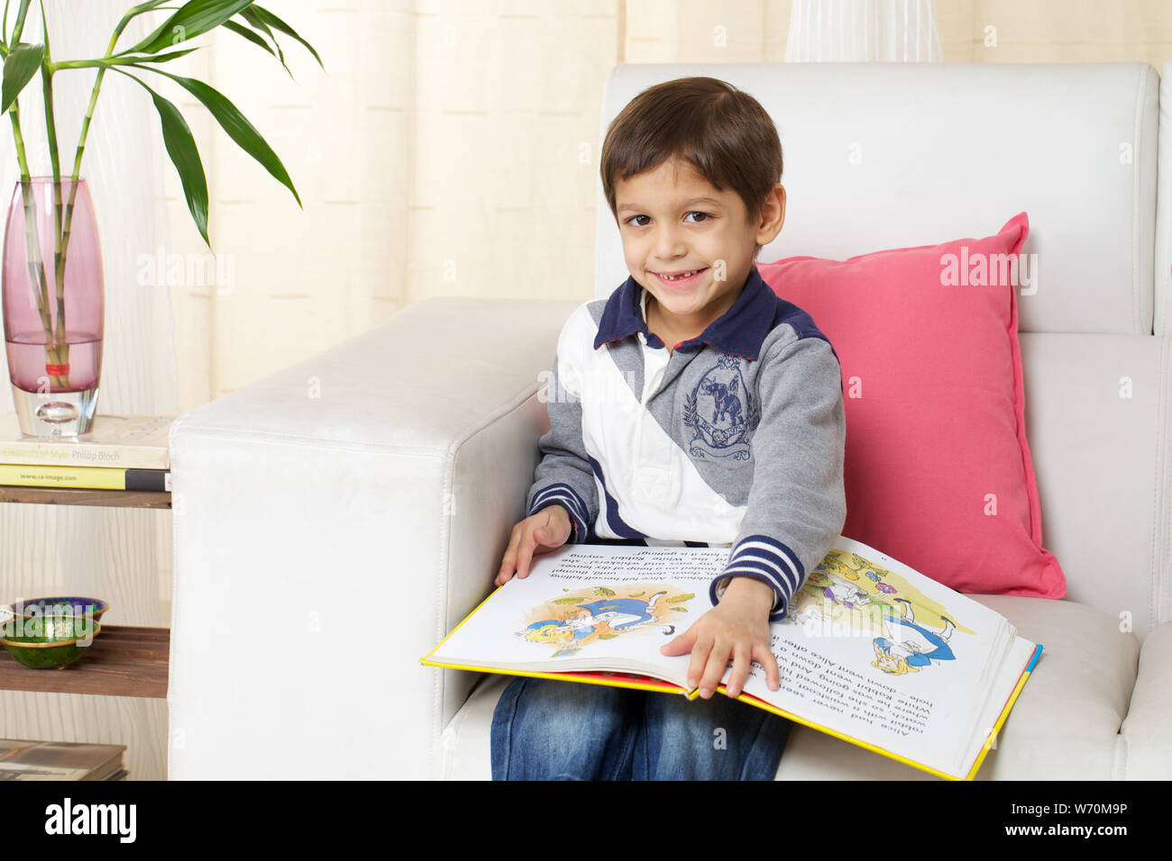 Boy reading a book at home Stock Photo - Alamy