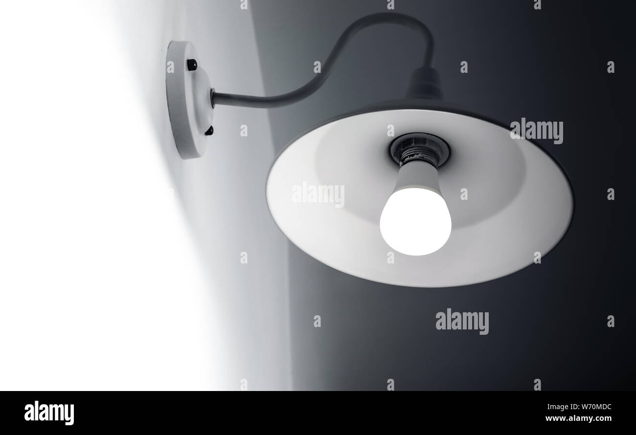 White Light bulb vintage design on wall Stock Photo - Alamy