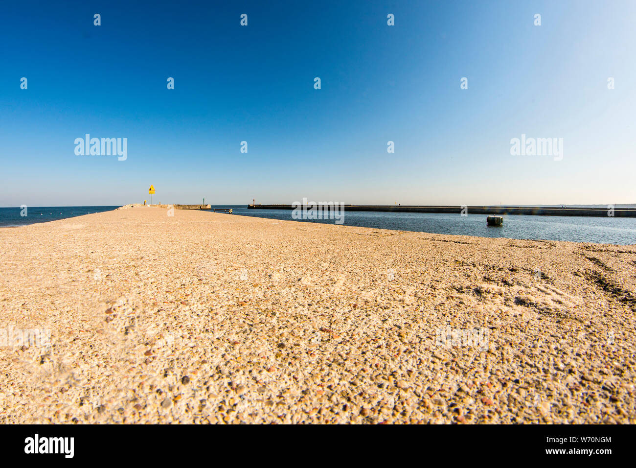 Mole of Ustka, Poland, wall with Baltis sea and blue sky Stock Photo ...
