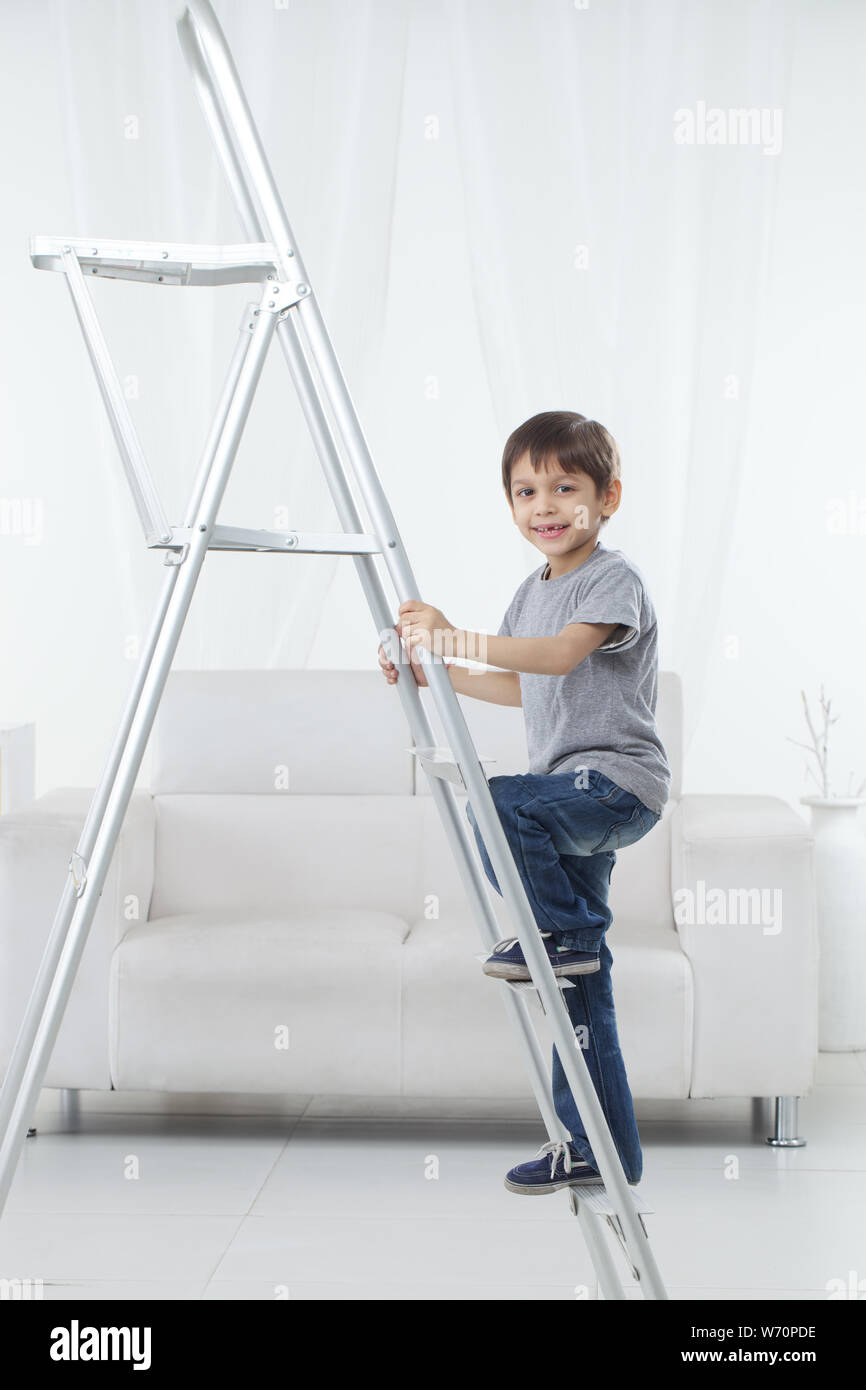 Boy climbing up ladder hi-res stock photography and images - Alamy