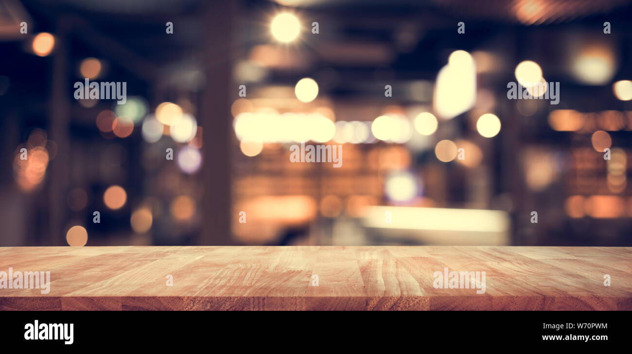 Wood table top (Bar) with blur light bokeh in dark night cafe ...