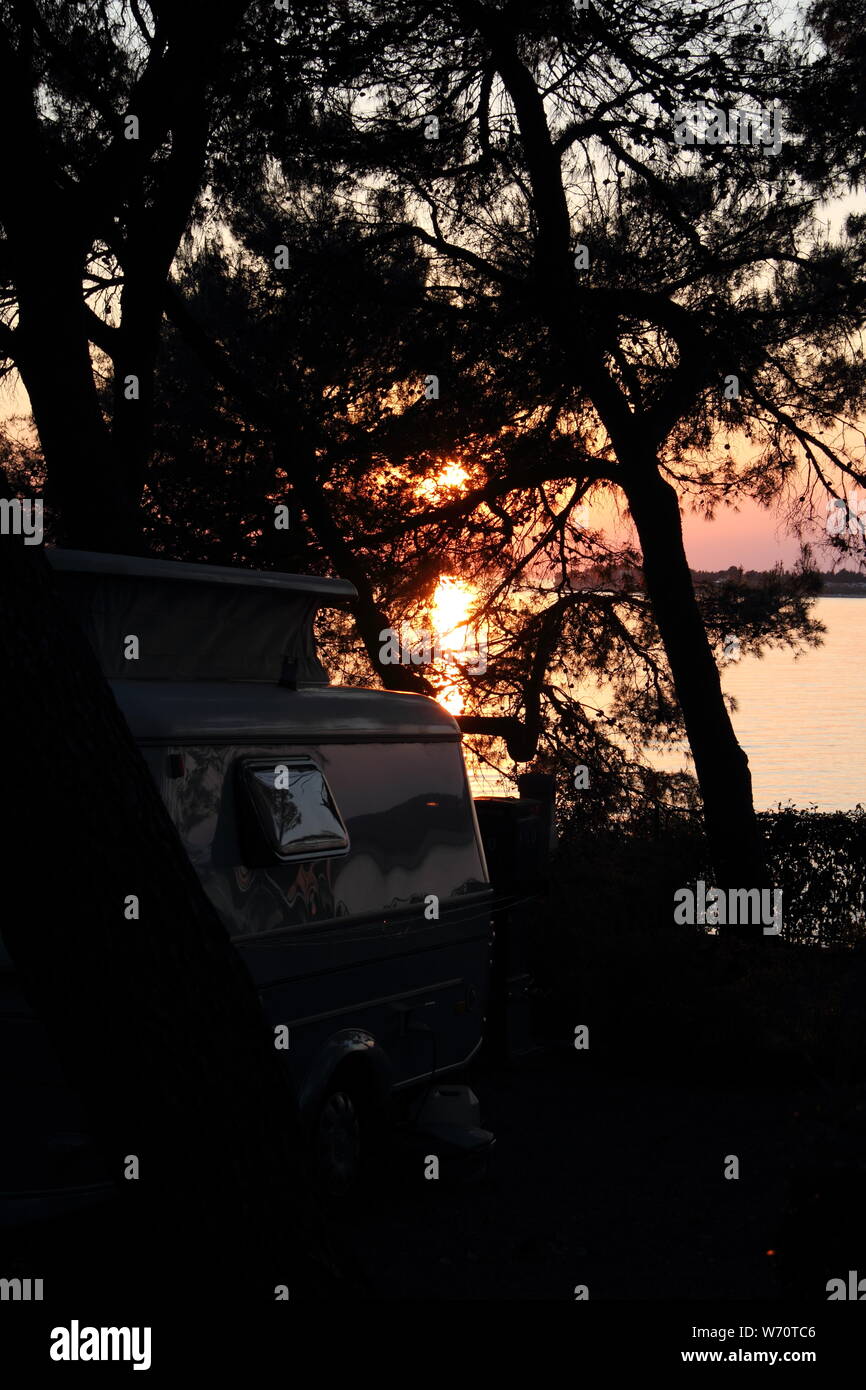 An old little caravan in the woods Stock Photo - Alamy