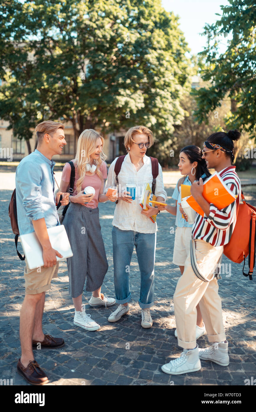 Excited students sharing impressions of the lecture Stock Photo - Alamy