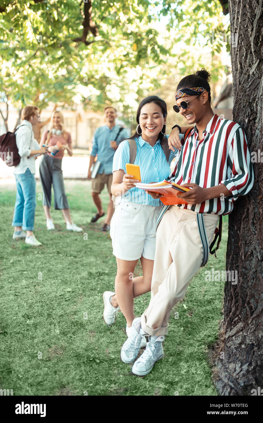Young couple laughing watching funny video together Stock Photo - Alamy