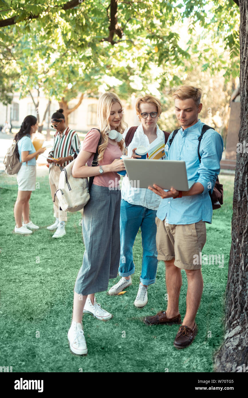 Three students working attentively on their project Stock Photo - Alamy