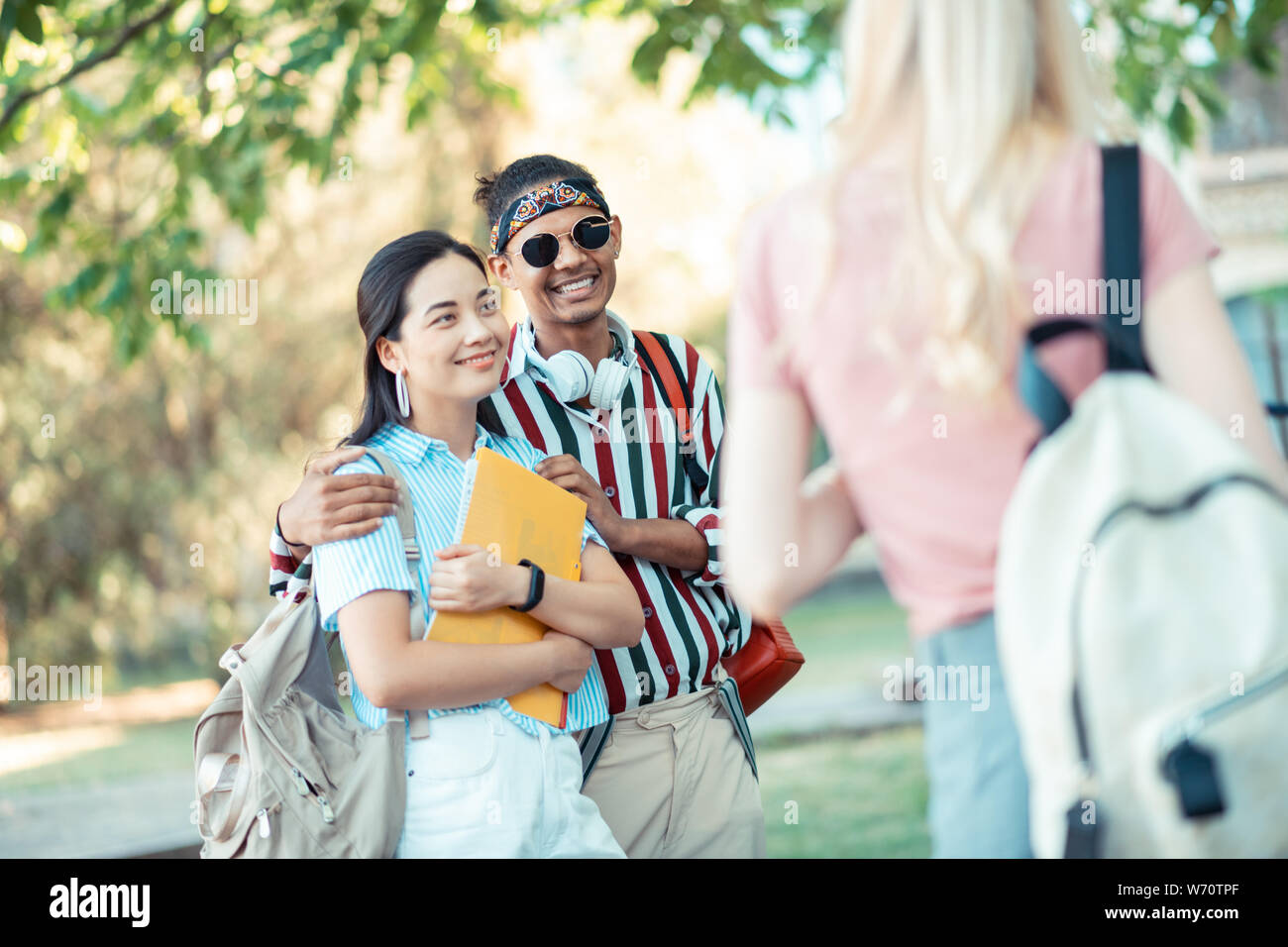 Beautiful couple of students going home together Stock Photo - Alamy