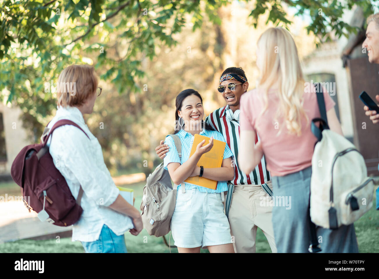 Group of students laughing at their jokes Stock Photo - Alamy
