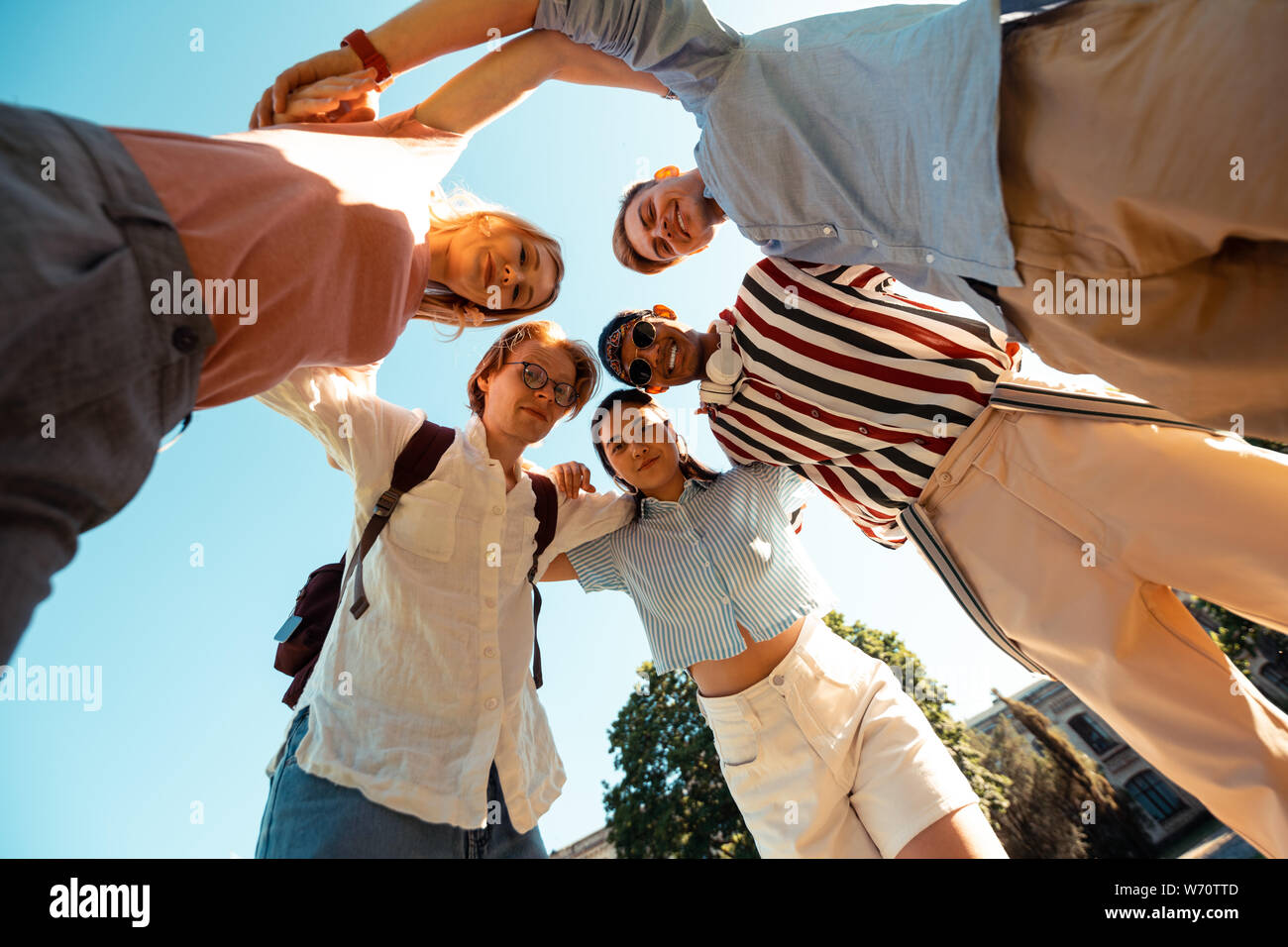 Students hugging each other forming a circle Stock Photo - Alamy