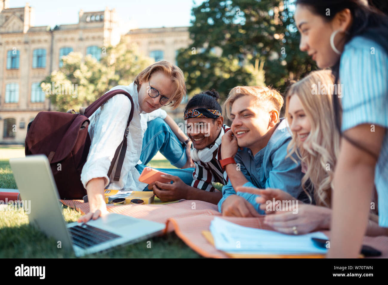 Students watching a movie about their group Stock Photo - Alamy