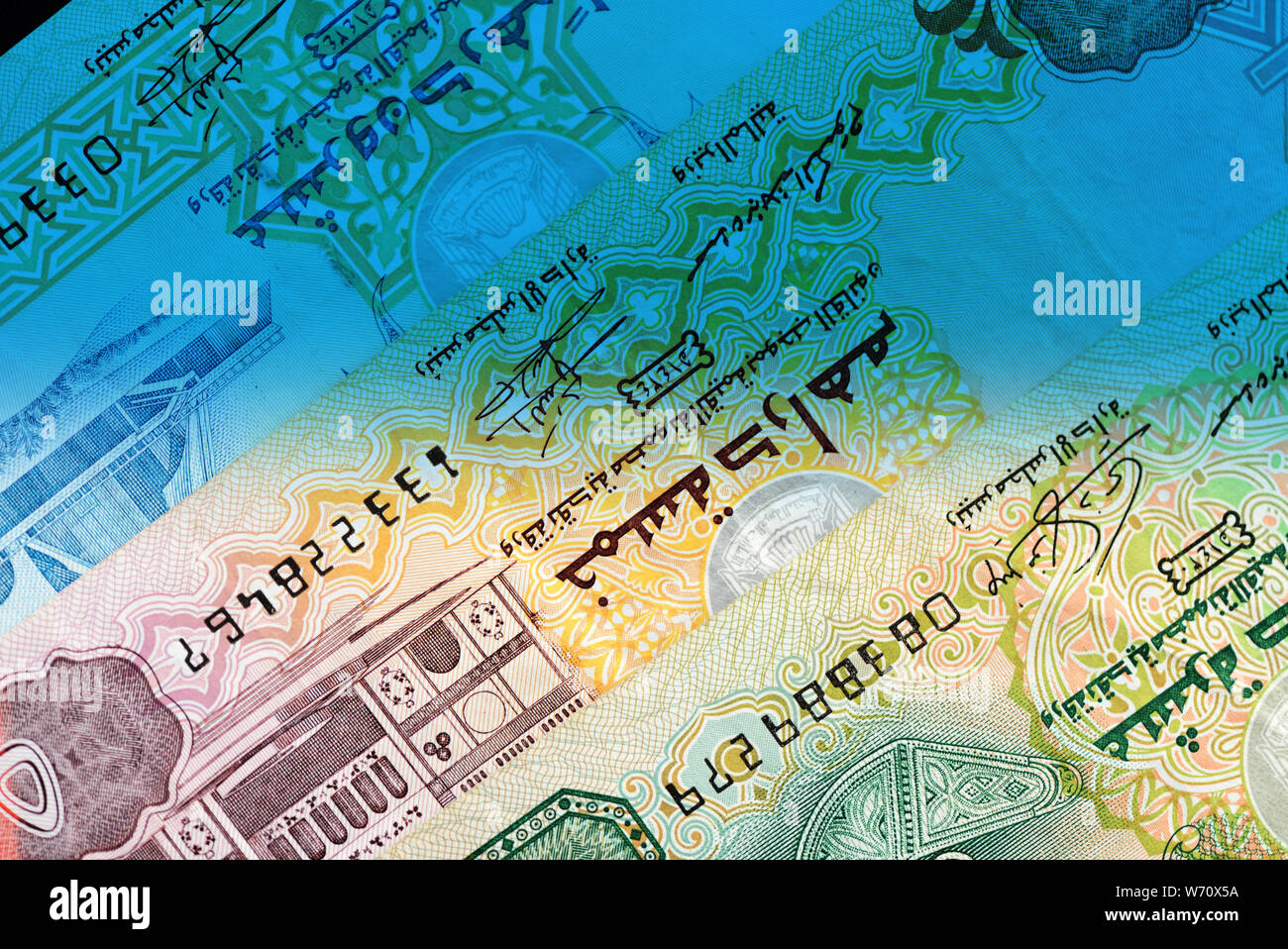 UAE dirham currency notes close up. Money background blue color toned ...