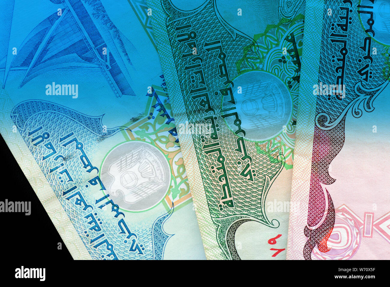 UAE dirham currency notes close up. Money background blue color toned ...
