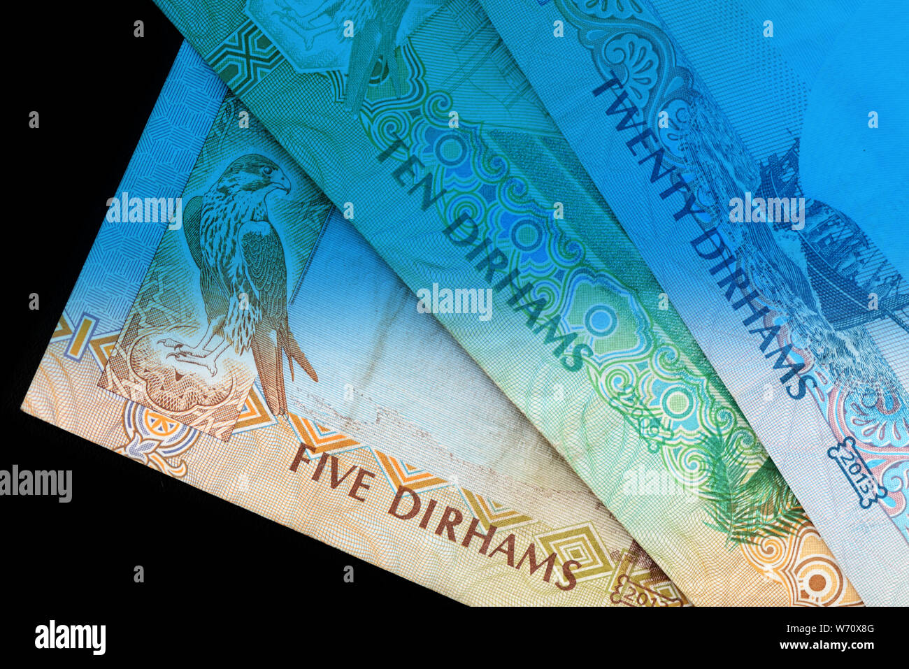 UAE dirham currency notes close up. Money background blue color toned ...