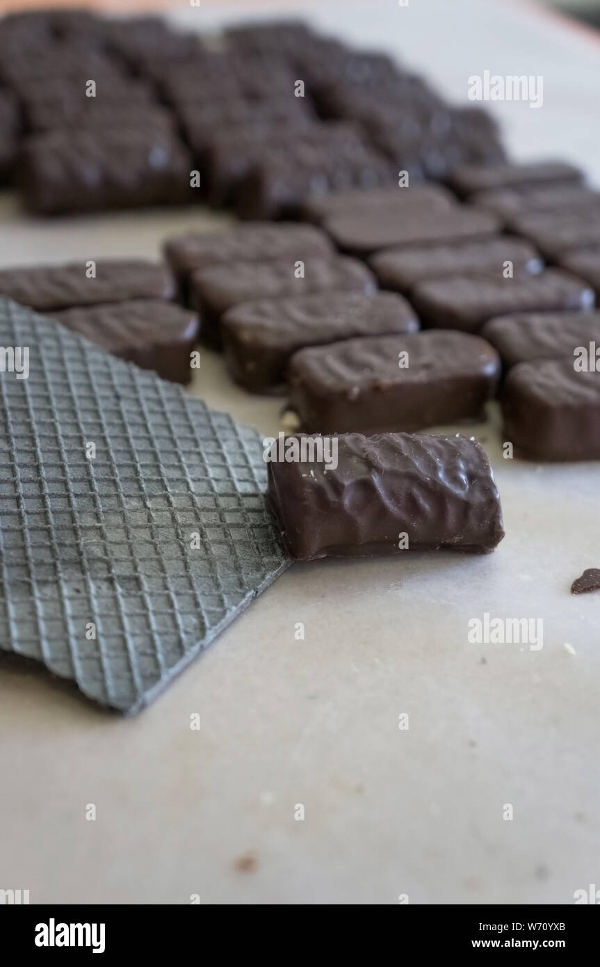 Chocolate, wafer sweets and black wafer sheet in chocolate production ...