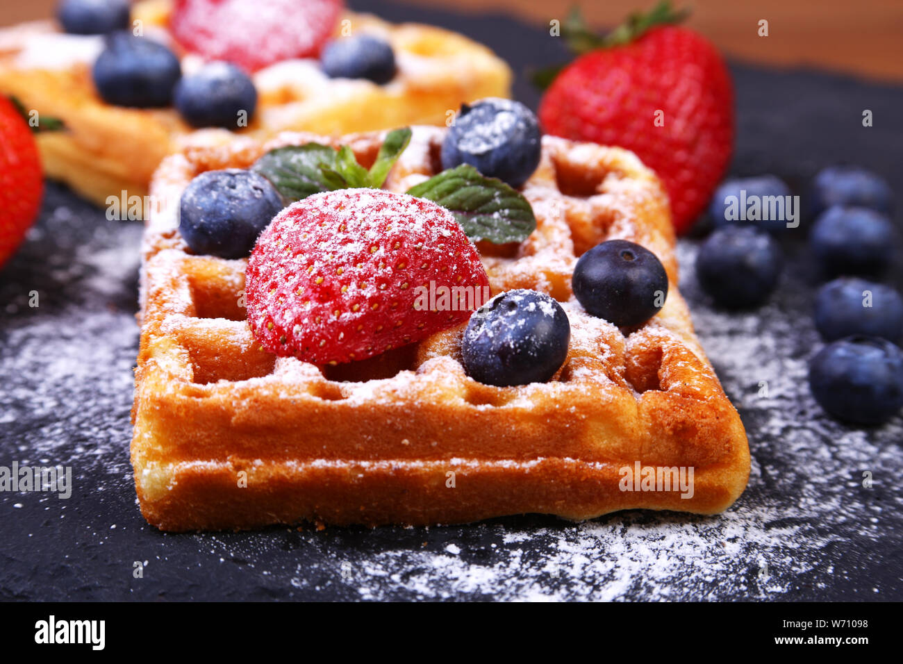 Homemade Traditional belgian waffles with fresh fruit, berries and ...