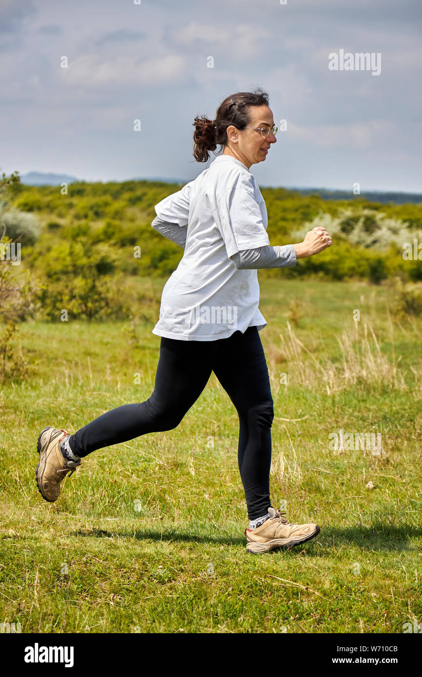 Spanish woman running on meadow Stock Photo - Alamy