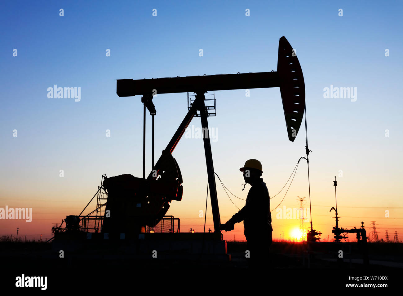 In the evening，oil field, the oil workers are working Stock Photo - Alamy
