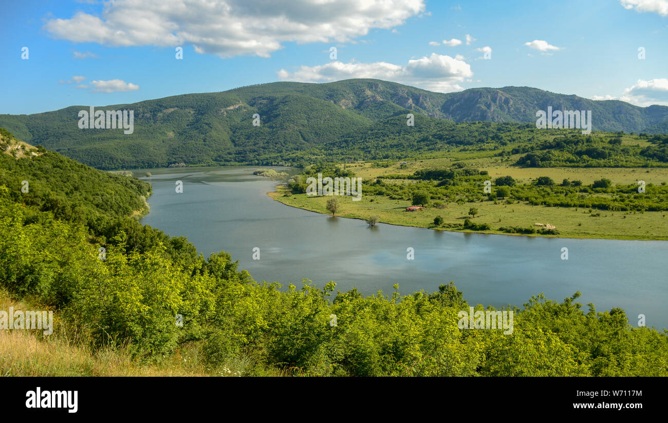 Landscape with river flowing between mountains Stock Photo - Alamy