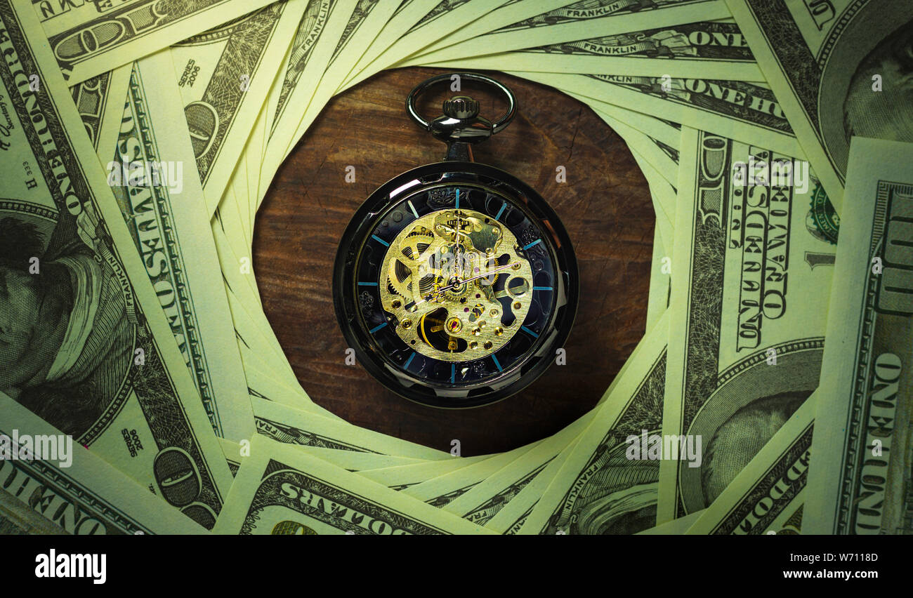 Pocket watch and dollar banknote stacking in darkness background ...