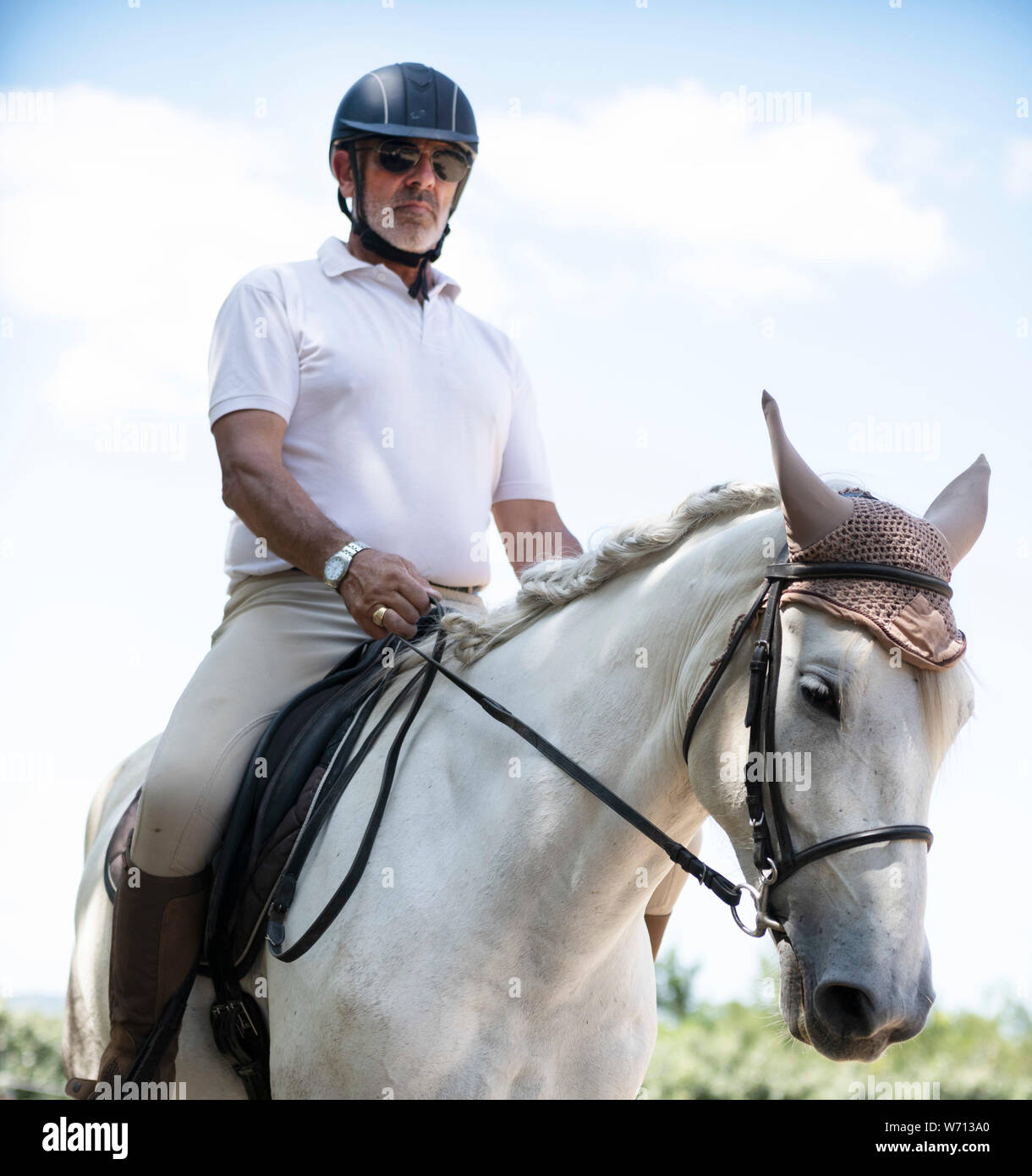 riding man, are training her young horse Stock Photo - Alamy