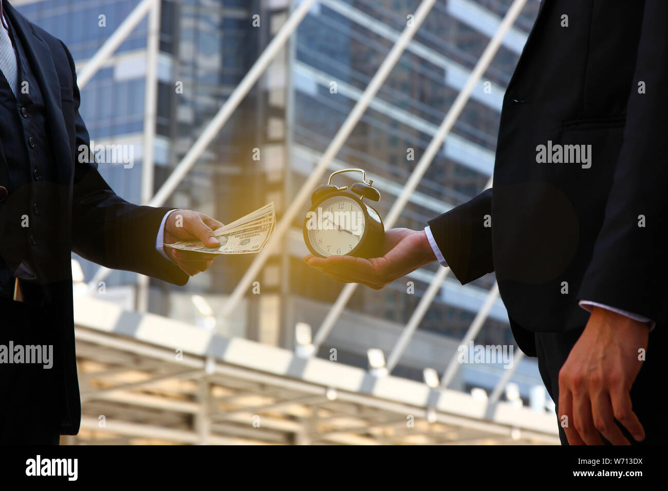 two business men are change watch and money in corruption concept Stock ...