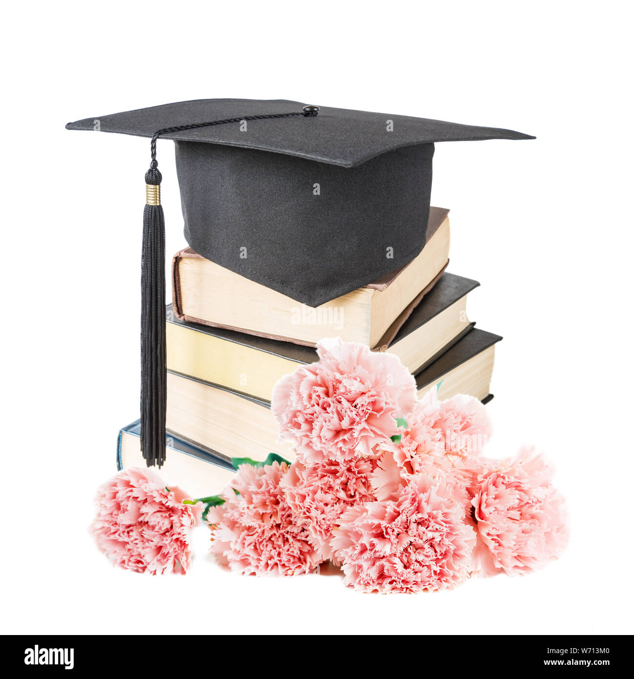 Black graduate (academic) hat on the stack of big books and a bouquet ...