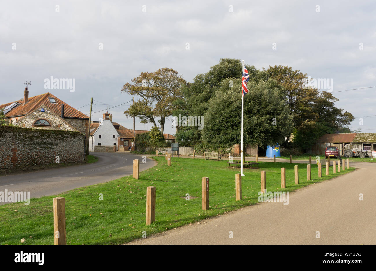 Village green, with flagpole and Union Jack, in the coastal village of ...