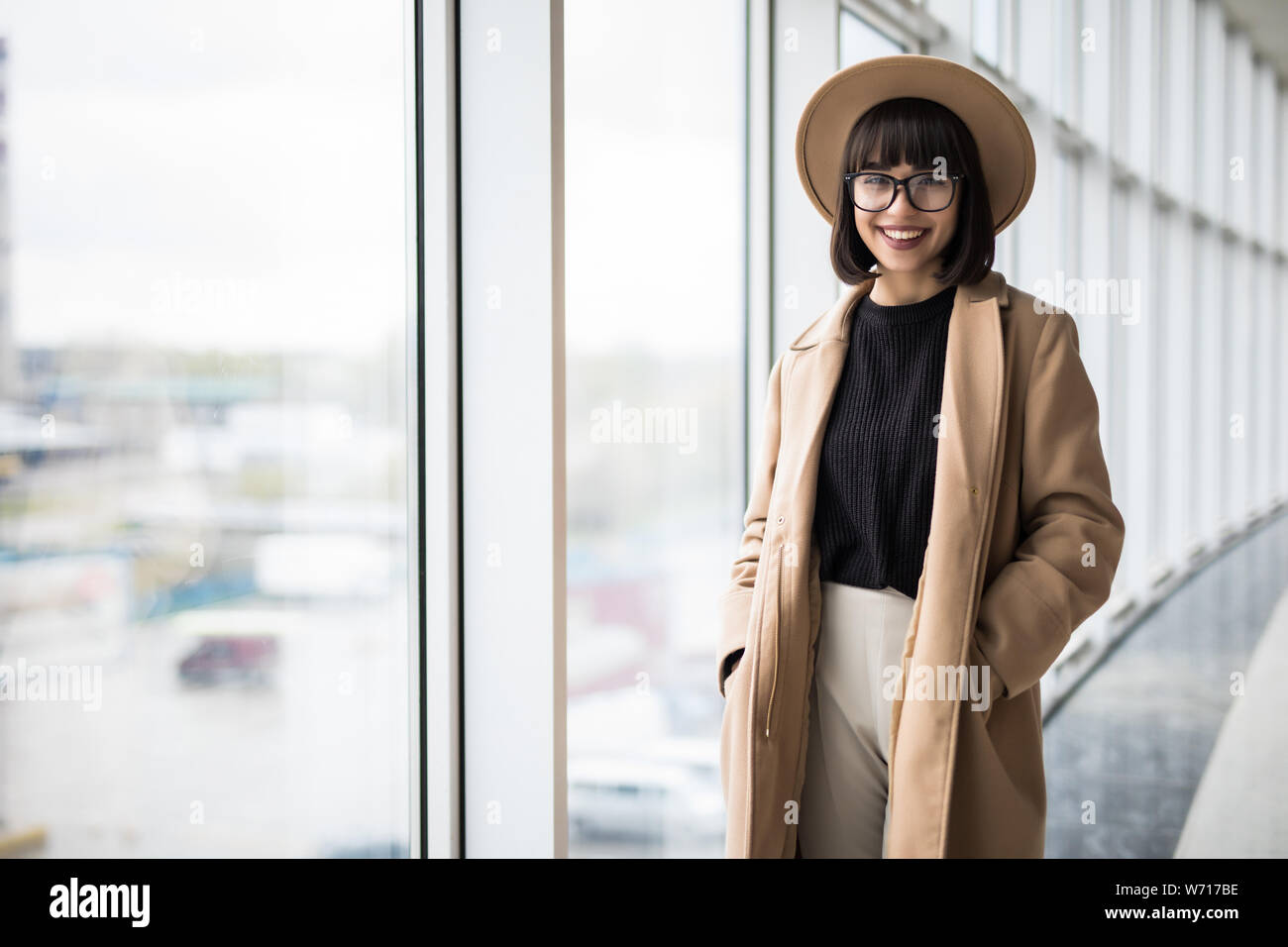 Attractive young businesswoman wearing glasses staring thoughtfully ...